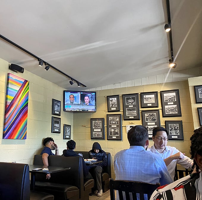 Black and white photos line yellow walls where diners gather, creating that rare space where strangers become temporary breakfast companions.
