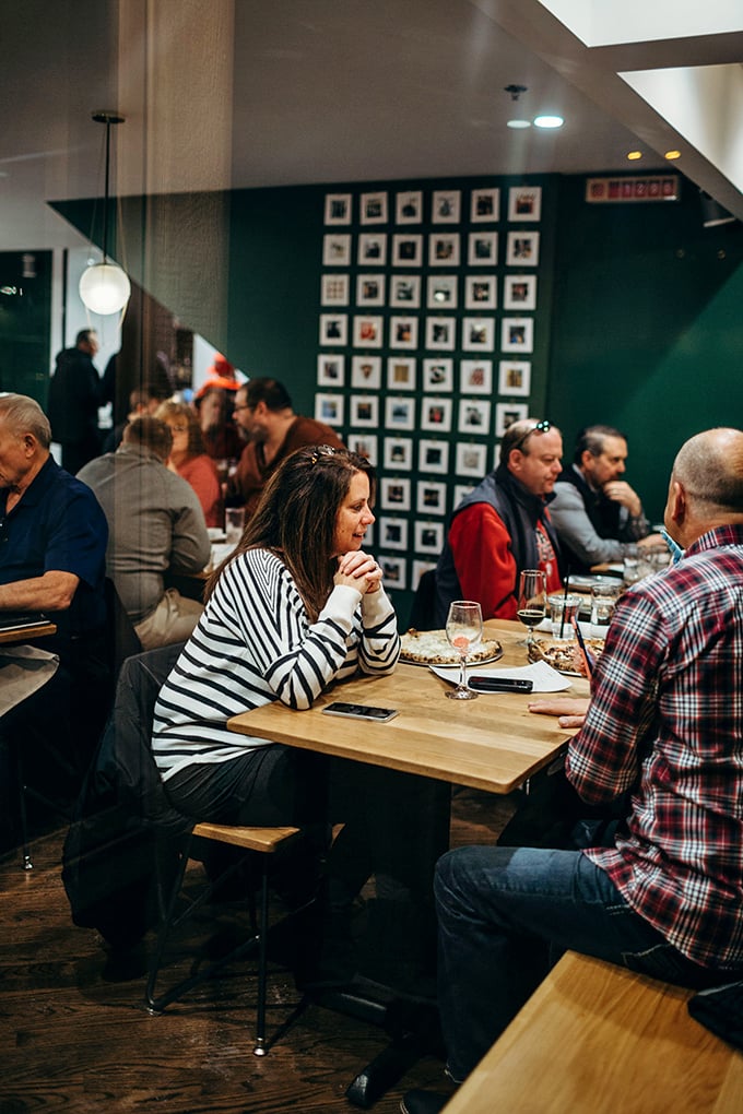The dining room hums with that magical energy that happens when good food meets good company in a space designed for both.