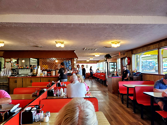 Where locals and tourists unite under the universal language of "please pass the parmesan" in comfortable red booths.