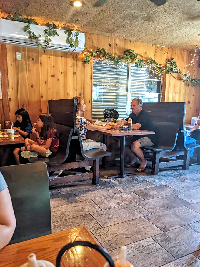 Families gather in booths beneath twinkling lights and ivy—creating memories over meals that will have them plotting return trips before dessert arrives.