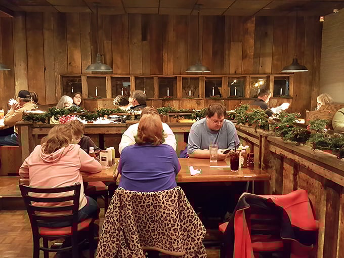 Where barbecue brings people together – wooden booths lined with greenery create intimate spaces for the serious business of enjoying smoked meats.