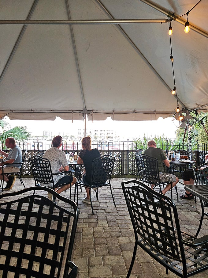 Under a white canopy with harbor views, diners experience the quintessential Florida moment—casual elegance with a side of salt air.