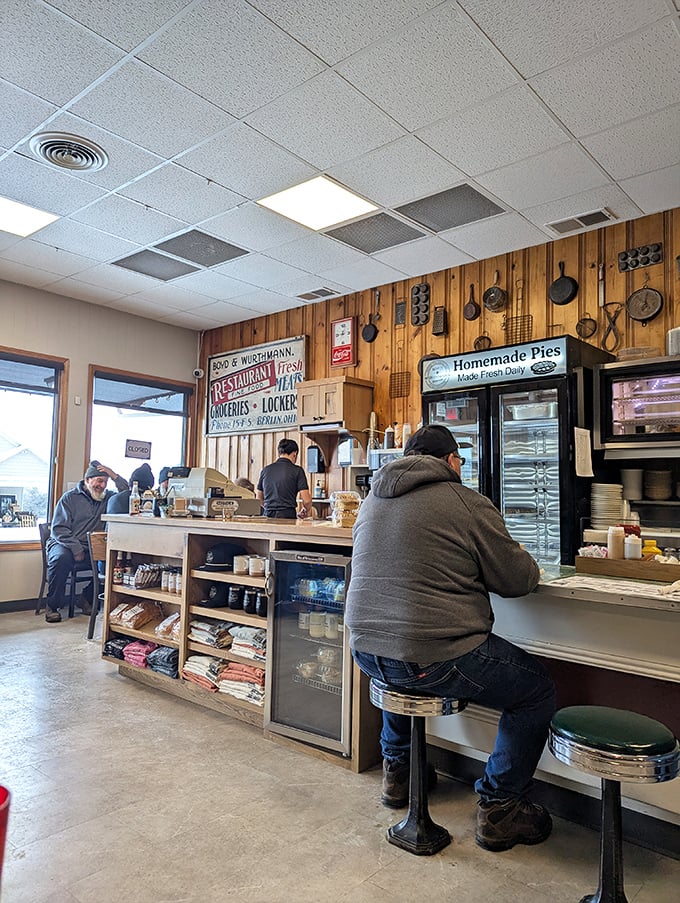 Where locals and visitors share tables and stories. The wood paneling has absorbed decades of laughter and satisfied sighs.