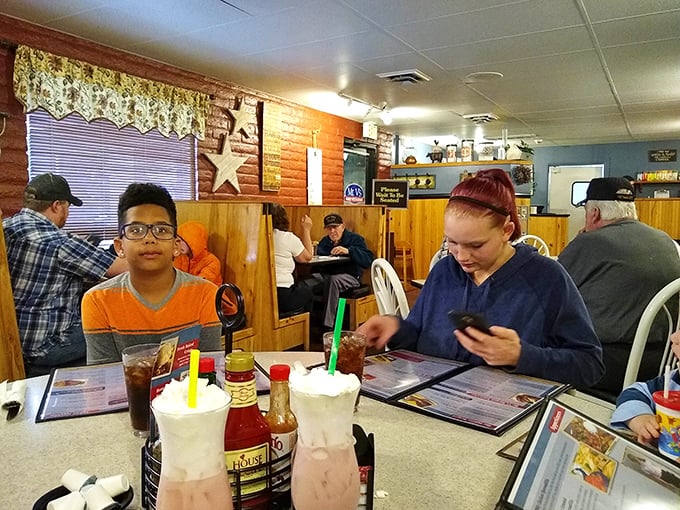 Where diner magic happens—patrons enjoying milkshakes and conversation in booths that have likely witnessed thousands of "remember when" stories.
