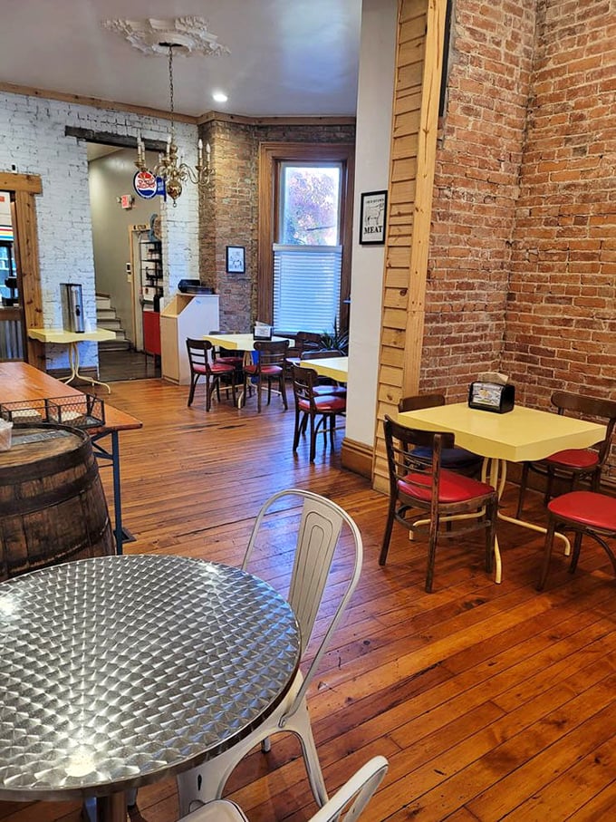 Yellow tables pop against rustic brick walls, creating dining spaces that feel both intimate and communal – the barbecue equivalent of a warm hug.