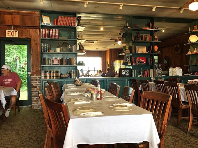 Bookshelves and white tablecloths create a dining room that feels like Sunday dinner at your favorite relative's house—if they happened to be catfish royalty.