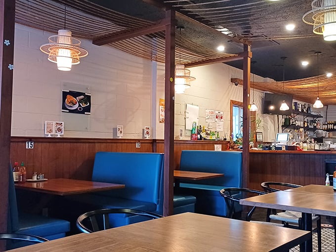 Blue booth seating and wooden dividers create intimate dining spaces that feel both modern and timeless—the perfect stage for culinary drama to unfold.