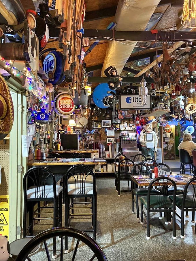 Dining under a canopy of curiosities—where fishing memorabilia and twinkling lights create the perfect backdrop for comfort food conversations.