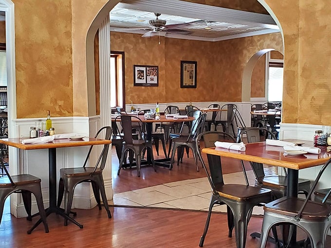 Warm faux-finished walls and elegant arches create dining spaces that feel intimate yet spacious—like being hugged by architecture with an Italian accent.