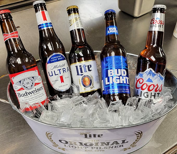 The beer bucket lineup reads like America's greatest hits album – familiar, reliable, and exactly what you want with fried chicken.