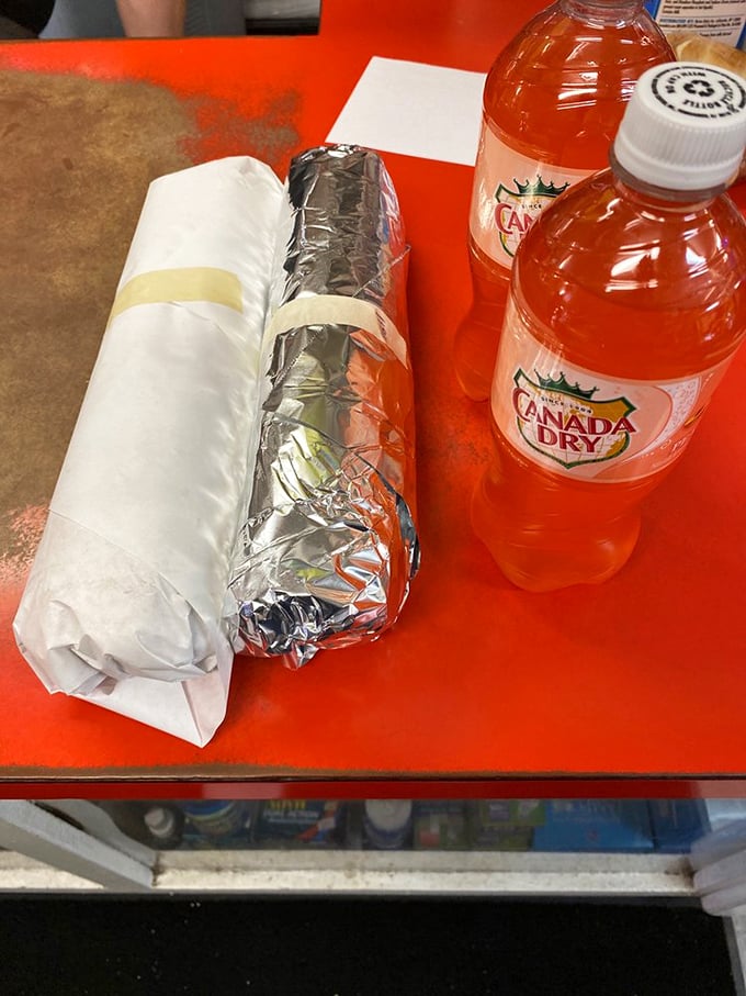 The classic pairing: wrapped sandwich treasures alongside Canada Dry – proof that some traditions need no improvement.