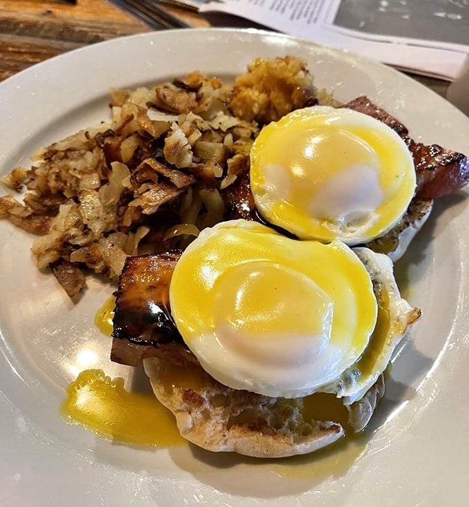 These eggs Benedict aren't messing around – perfectly poached eggs perched atop ham like mountain royalty. 