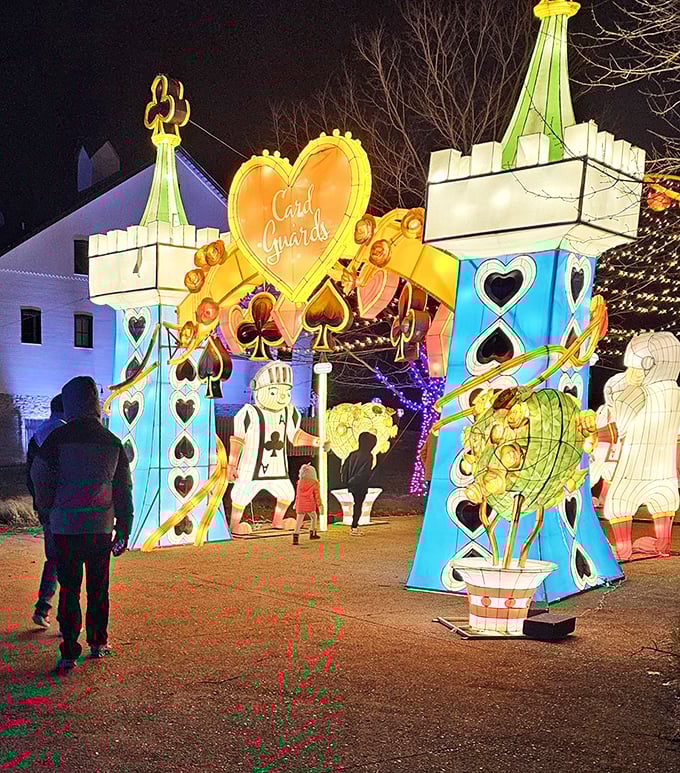 When night falls, the wonderland awakens with illuminated card guards standing sentinel over this kingdom of whimsy.