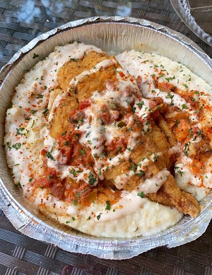 Fish over creamy grits with all the fixings—Southern comfort food that makes you understand why people write songs about going home.