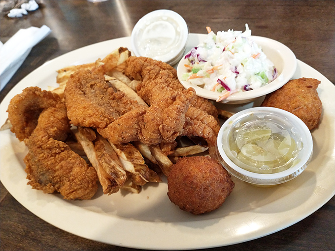 A Southern seafood feast that proves landlocked Arkansas knows its way around a fryer – crispy catfish, hushpuppies, and slaw that sings with freshness. 