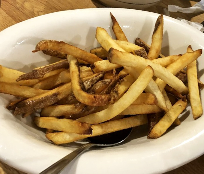 French fries cut by actual humans—what a concept!—crispy outside, fluffy inside, perfect every time.