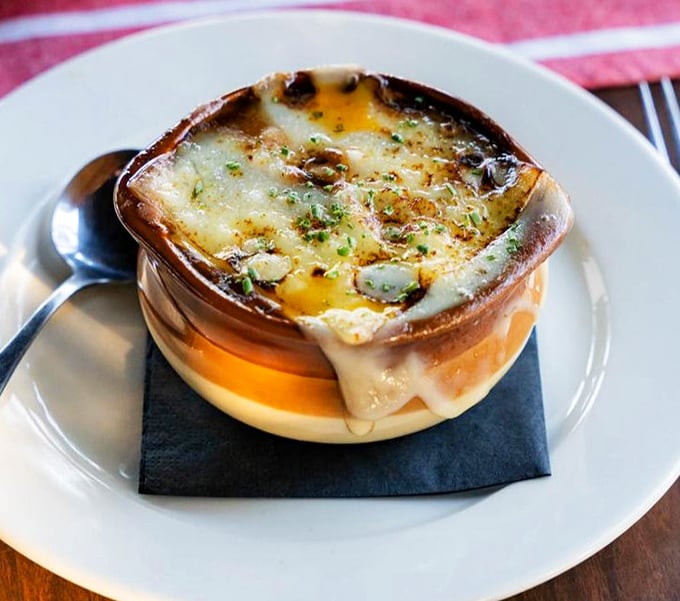 French onion soup that's wearing a golden crown of bubbling cheese—royalty in a crock that's worth the inevitable chin dab.