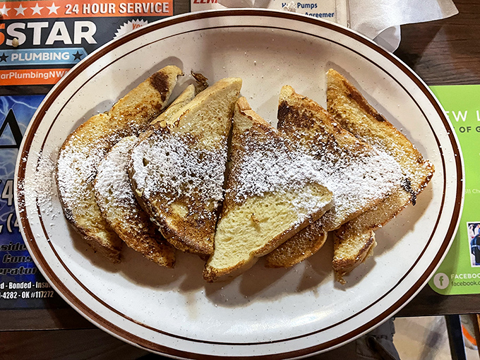 French toast dusted with powdered sugar—simple perfection that reminds you sometimes the classics don't need reinventing, just respect and good execution.