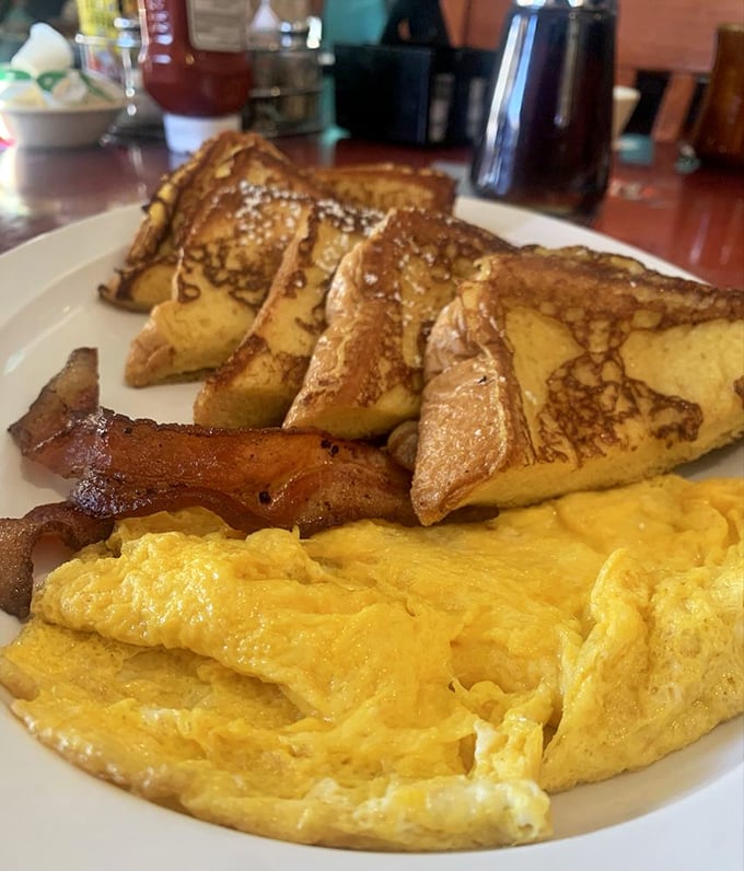 French toast that's achieved the perfect golden-brown tan, accompanied by bacon that's exactly how bacon should be—present.