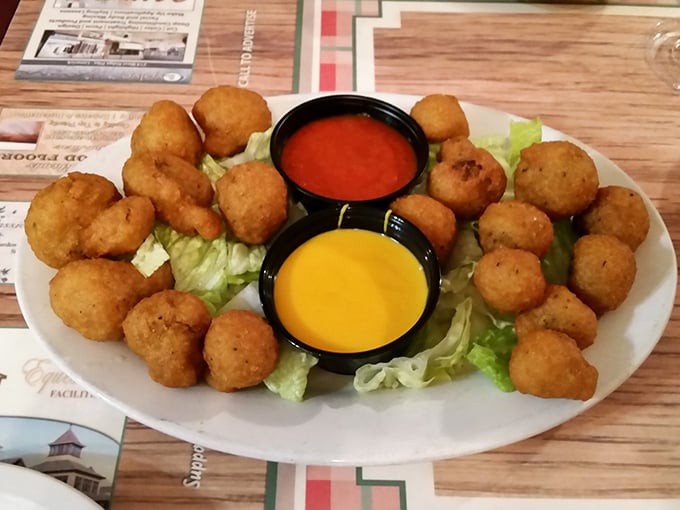 Golden-fried mushrooms that crunch like autumn leaves, served with dipping sauces that make you wonder why vegetables ever needed convincing.