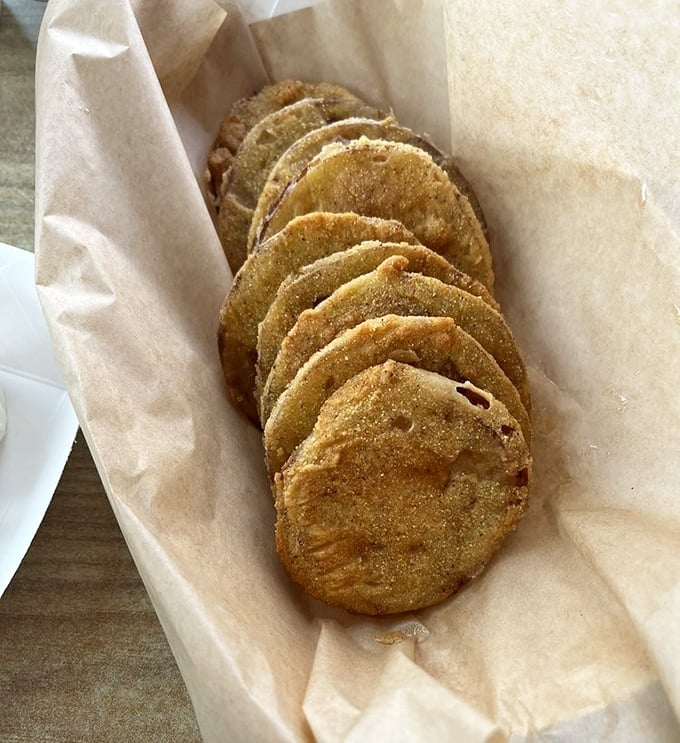 Fried green tomatoes stacked like golden coins – a Southern currency that's always accepted at the table of good taste.