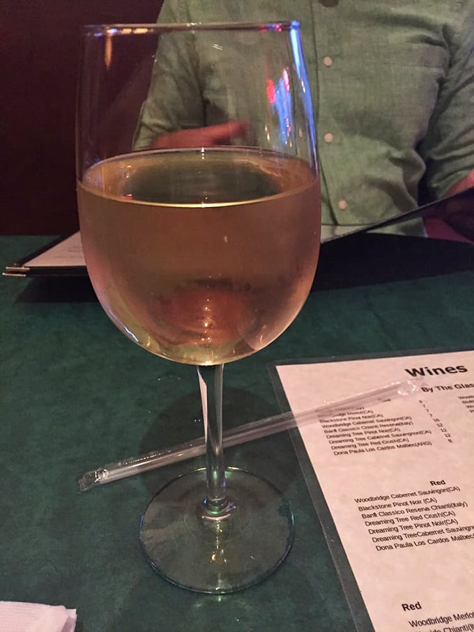 A glass of white wine alongside the wine list—because what's a proper Italian meal without the perfect grape companion? Salute to simple pleasures!