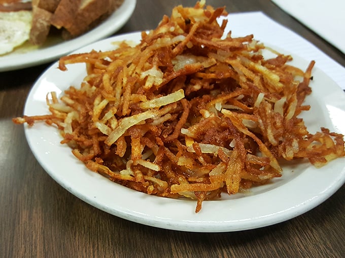 Crispy, golden hash browns that crackle with each forkful—the unsung hero of any proper breakfast plate and worth every delicious, oil-crisped calorie.