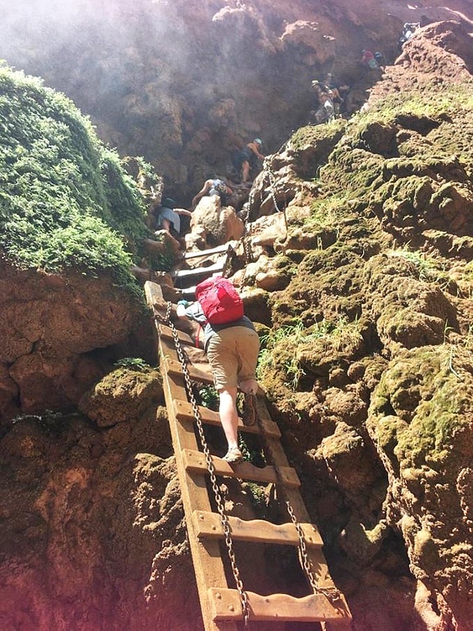 Fellow adventurers become tiny specks against massive canyon walls, putting human ego in proper perspective.