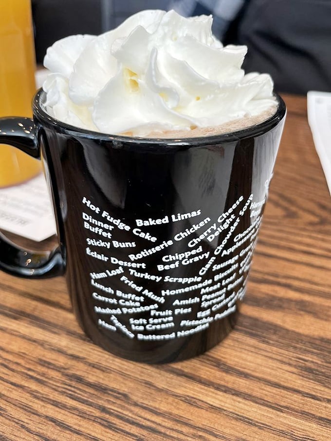 Hot chocolate elevated to an art form with a mountain of whipped cream. The mug listing menu favorites serves as both souvenir and roadmap for future visits.