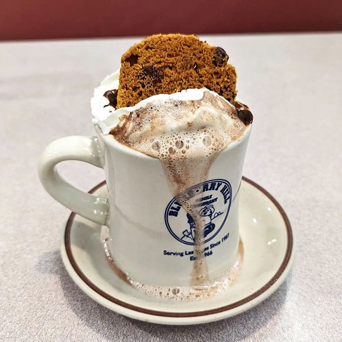 Hot chocolate topped with a slice of cake—because sometimes one dessert simply isn't enough to heal what ails you.