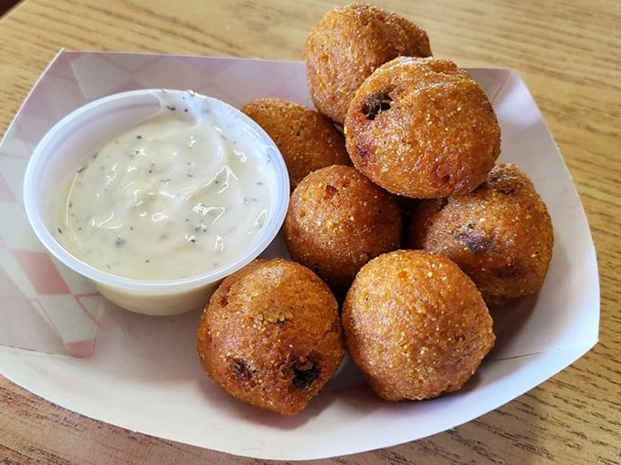 Hush puppies with that perfect crispy exterior giving way to a soft, savory interior – the comfort food you didn't know you were missing your entire life.