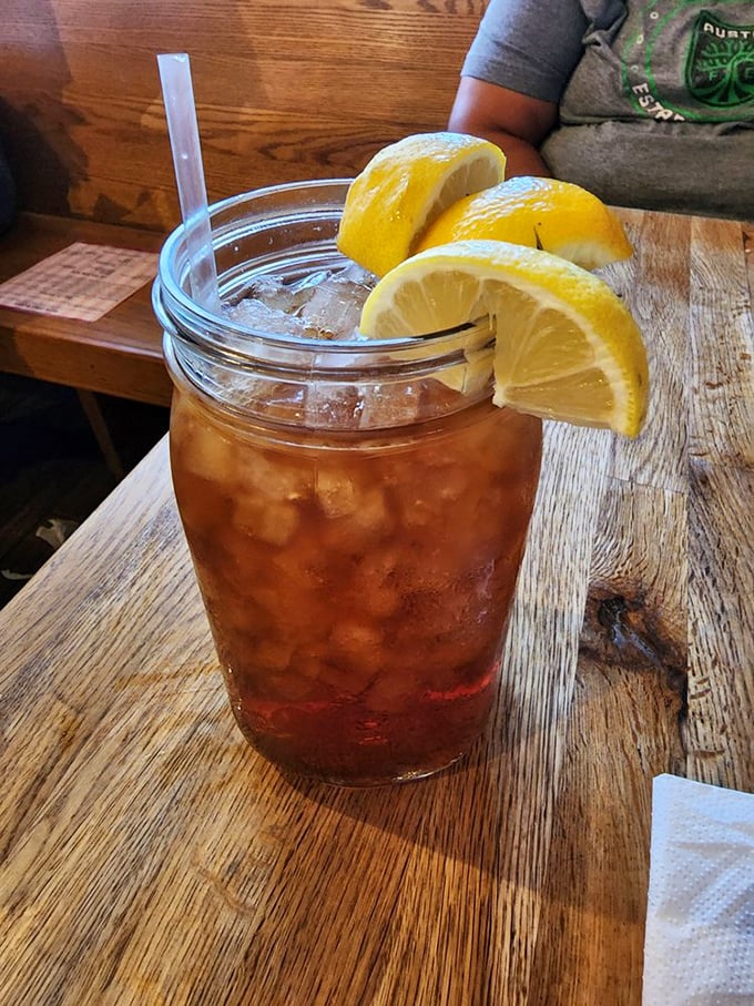 Sweet tea served in a mason jar with lemon wedges isn't just a beverage—it's liquid Southern hospitality that makes Texas heat bearable.