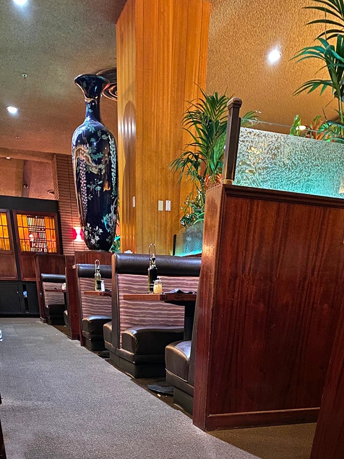 The warm wood tones and elegant booth dividers create dining spaces that feel both intimate and part of something larger – like your own private Italy.