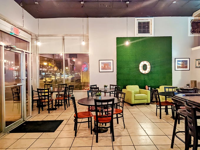 The bright, airy dining space features a statement green wall—a playful nod to the restaurant's name that anchors the room.