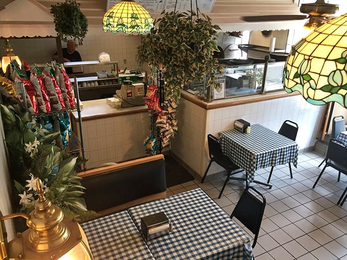 The other dining area showcases more Tiffany-style lamps and checkered tablecloths—a time capsule of neighborhood restaurant aesthetics that never goes out of style.