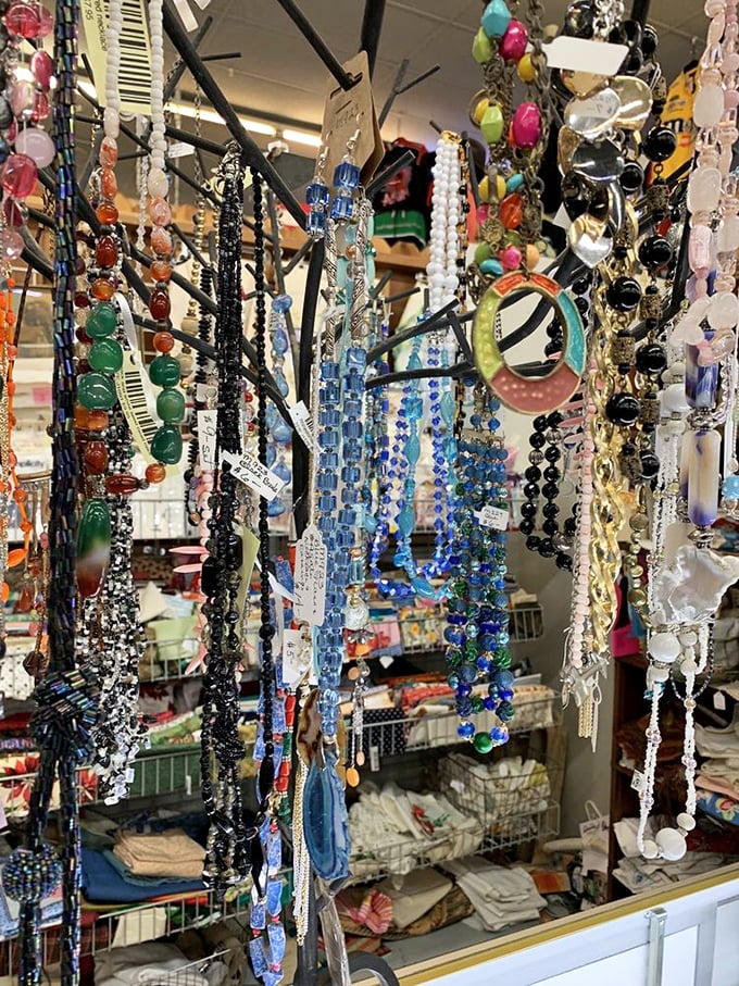 A rainbow of beads, crystals, and vintage jewelry dangles enticingly, promising to transform ordinary outfits into conversation-starting statements.