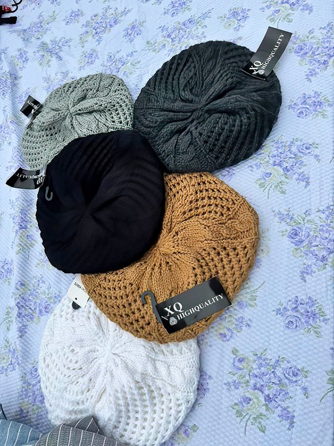 Knitted berets with tags still attached—the unicorns of flea markets. Someone's impulse buy becomes your winter wardrobe upgrade.