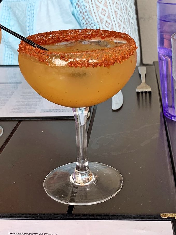 That's not just a margarita—it's liquid sunshine with a chile-salt rim that perfectly balances sweet, sour, and spicy in one gorgeous glass.