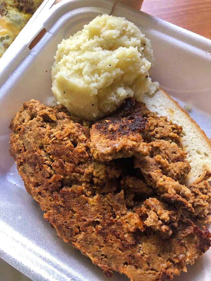 Meatloaf and mashed potatoes that could end family feuds—comfort food diplomacy at its finest on a humble takeout plate.