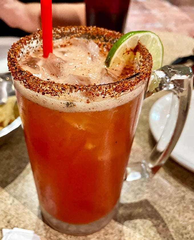 A michelada with its tajin-crusted rim and lime garnish—part cocktail, part appetizer, all delicious. Beer has never looked so dressed up.