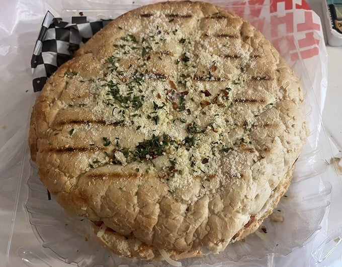 The muffuletta—a sandwich so serious about its mission it needs to be measured in diameter rather than length. This is bread-and-filling architecture at its finest.