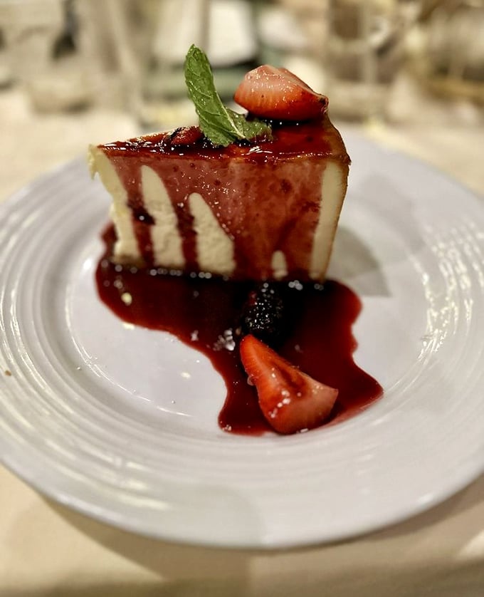 New York cheesecake with berry sauce and fresh strawberries—rich, creamy, and absolutely worth saving room for after all that seafood.