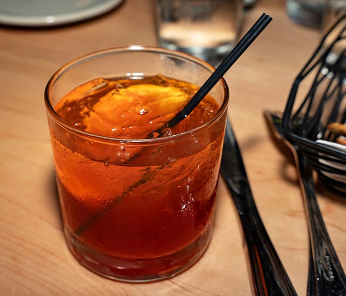 An old fashioned that looks like liquid amber in the glass—the kind of cocktail that makes you want to discuss property taxes or retirement plans.