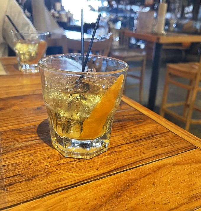 An old fashioned that's actually made the old-fashioned way—amber liquid catching the light like a sunset you can sip.