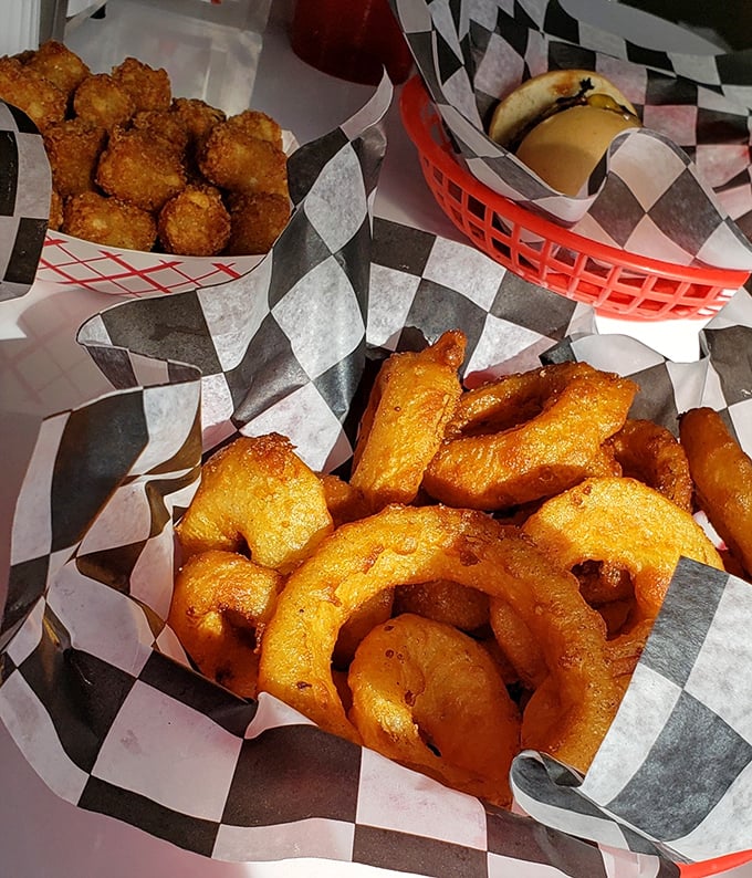 Golden rings and crispy tots—the supporting actors that often steal the show. Diner food poetry served in checkered paper.
