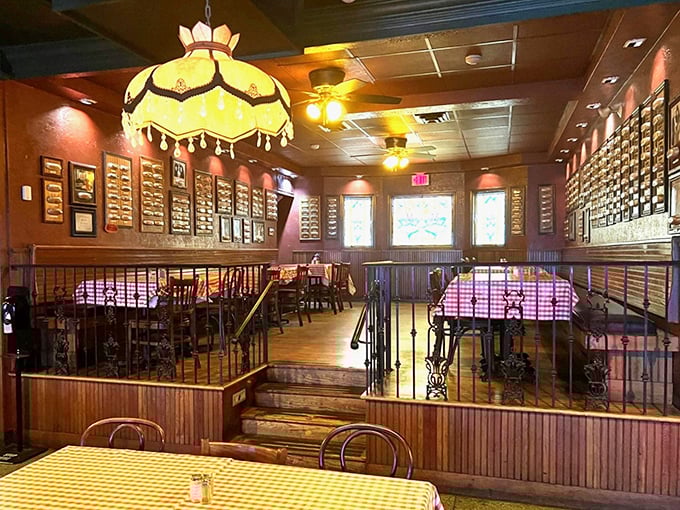 The warm glow of vintage-style lamps illuminates walls covered with signed hot dog buns—Toledo's unique version of Hollywood's Walk of Fame.
