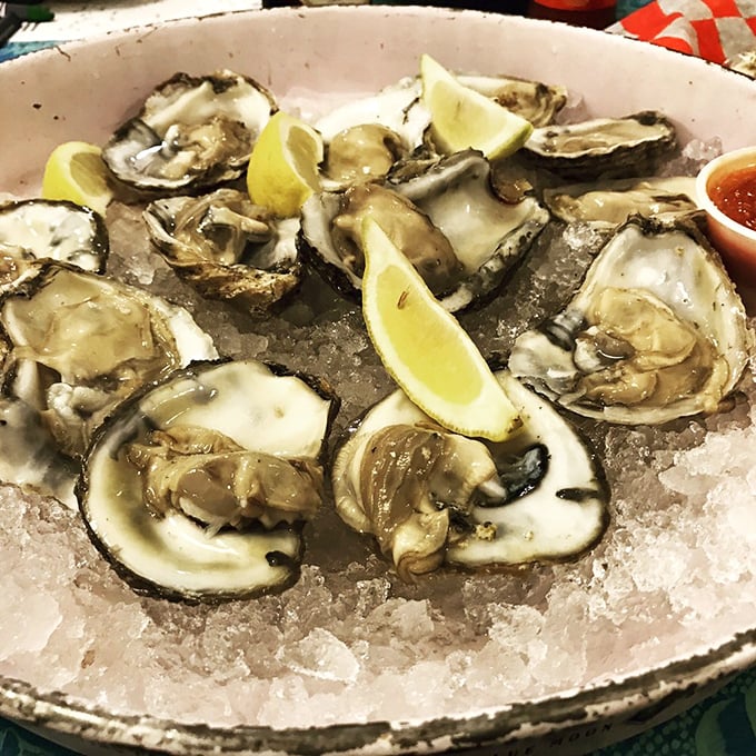 Fresh oysters on ice, glistening like jewels. These briny treasures offer a pure taste of the ocean—just add a squeeze of lemon and prepare for bliss.