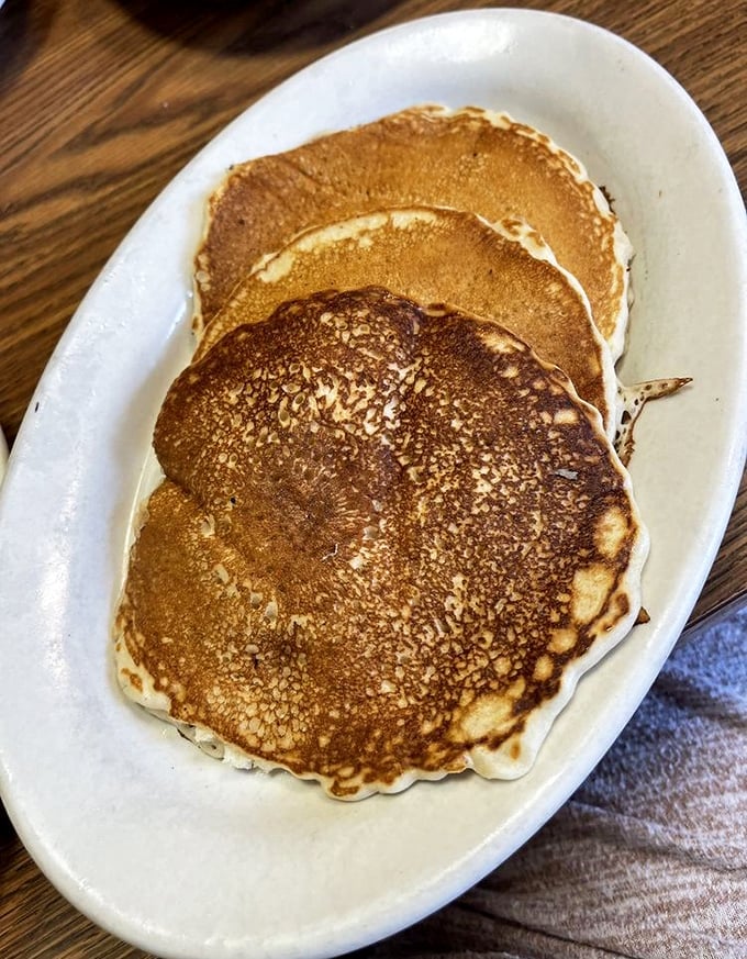 These pancakes aren't just round—they're perfectly bronzed discs of happiness that make you question why anyone would ever skip breakfast.