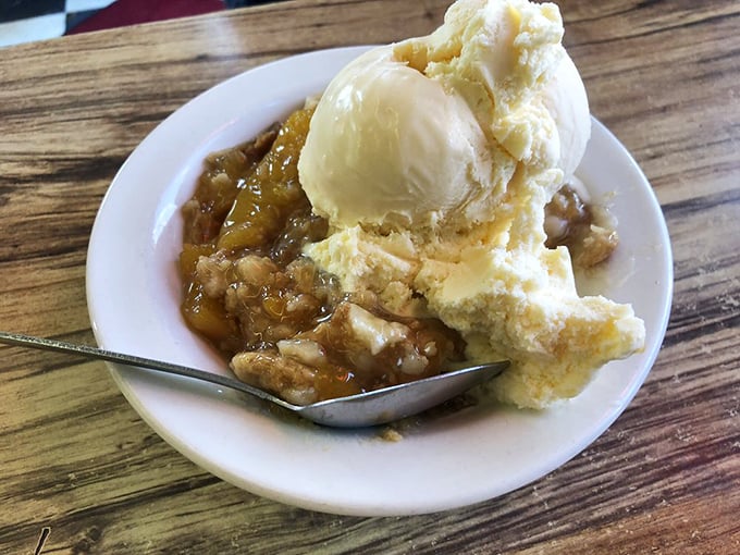 Peach cobbler and ice cream melting into sweet harmony. The perfect finale to a BBQ symphony, proving McClard's knows how to end on a high note.