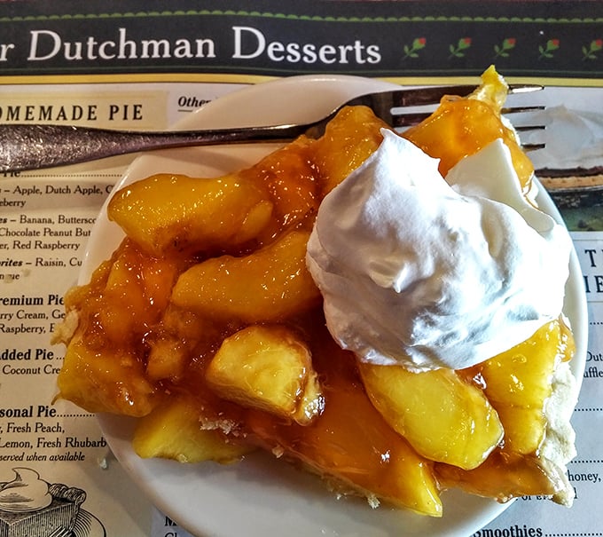 This isn't just peach pie—it's summer captured in a dessert, topped with ice cream melting like snowflakes on a warm Ohio afternoon.